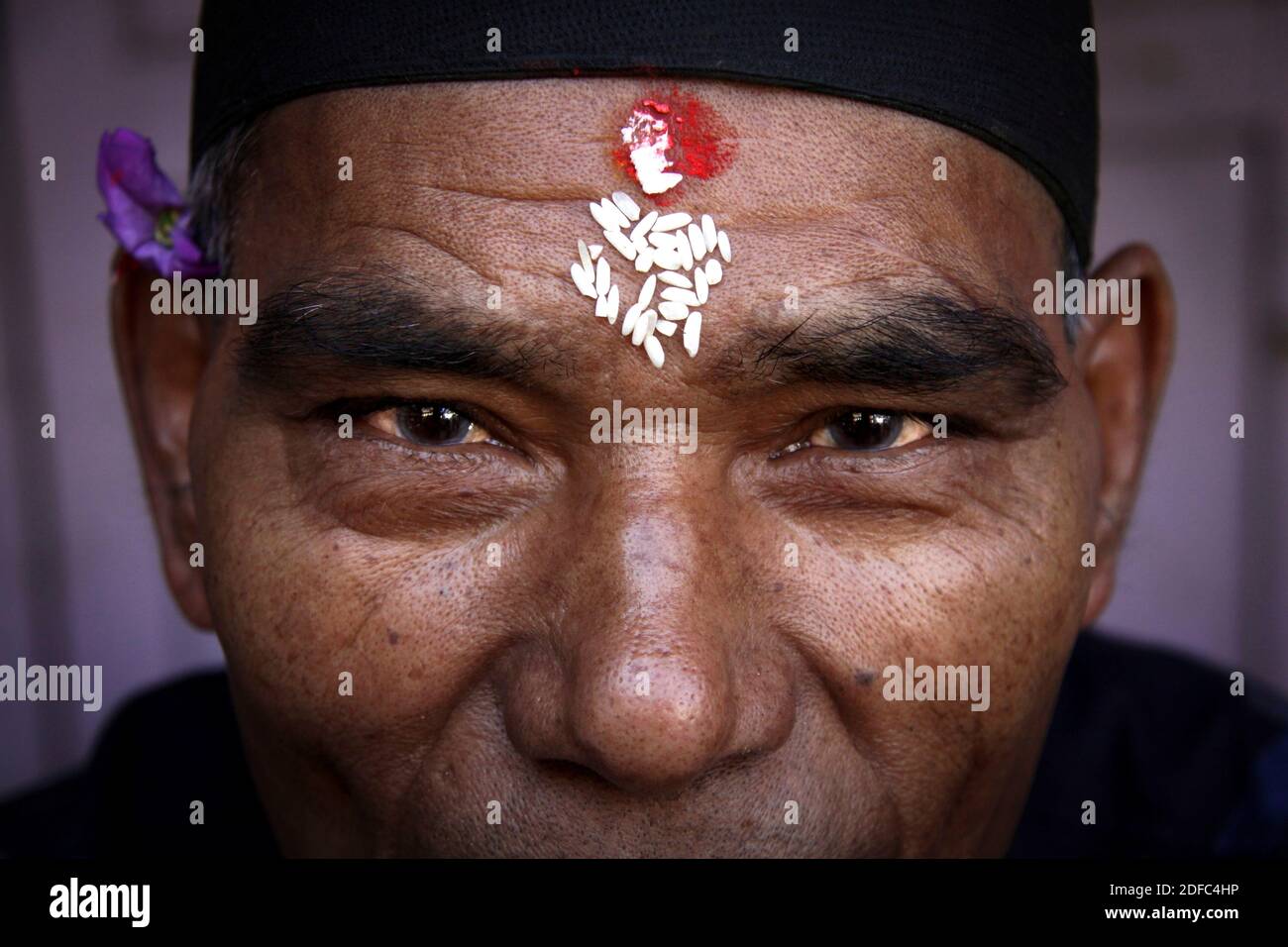 Nepal, portrait of Nepalese Newar man with tilak and grains of rice on ...