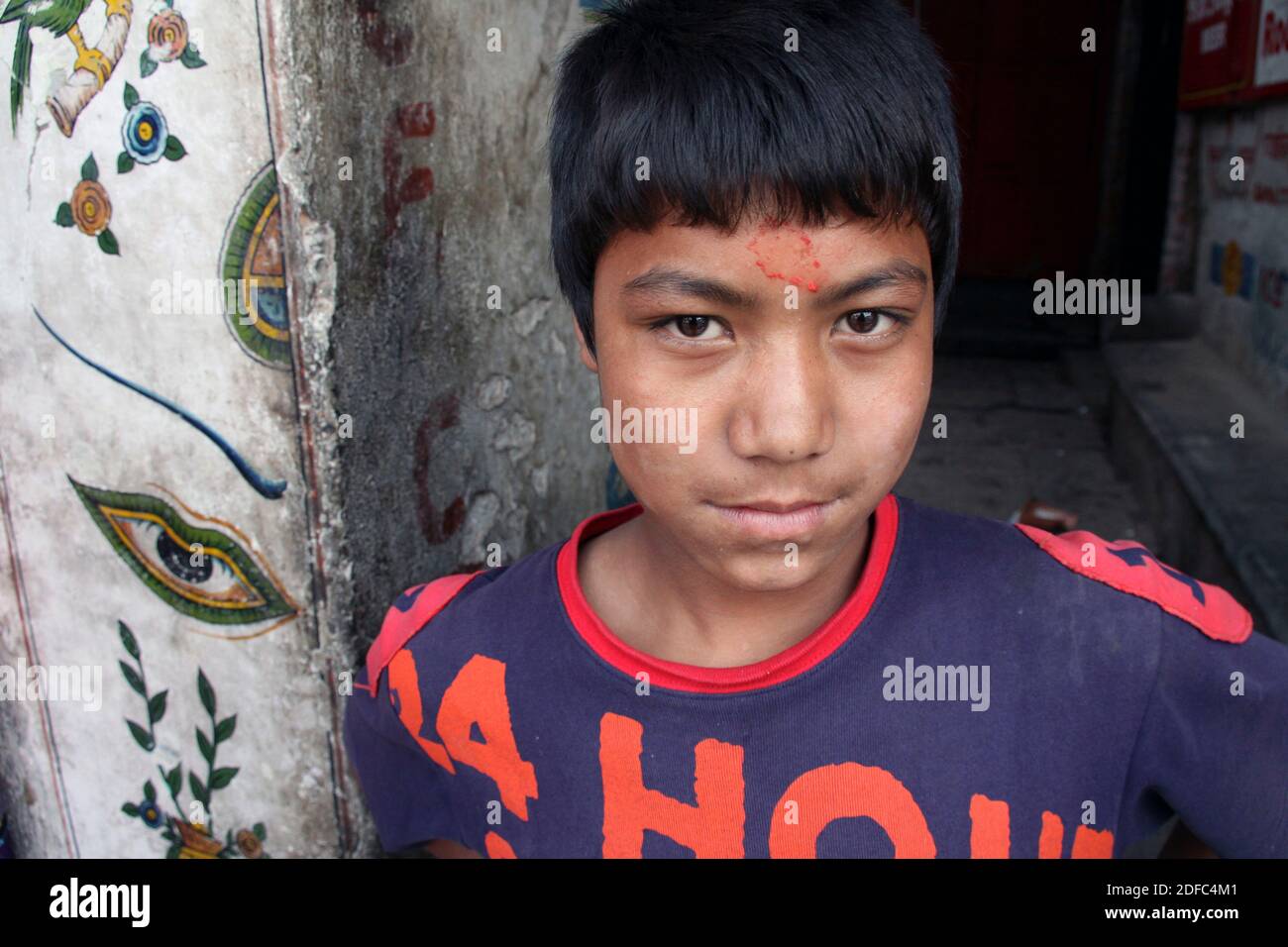 Nepal, portrait of young Nepalese man with traditional tilak on his ...