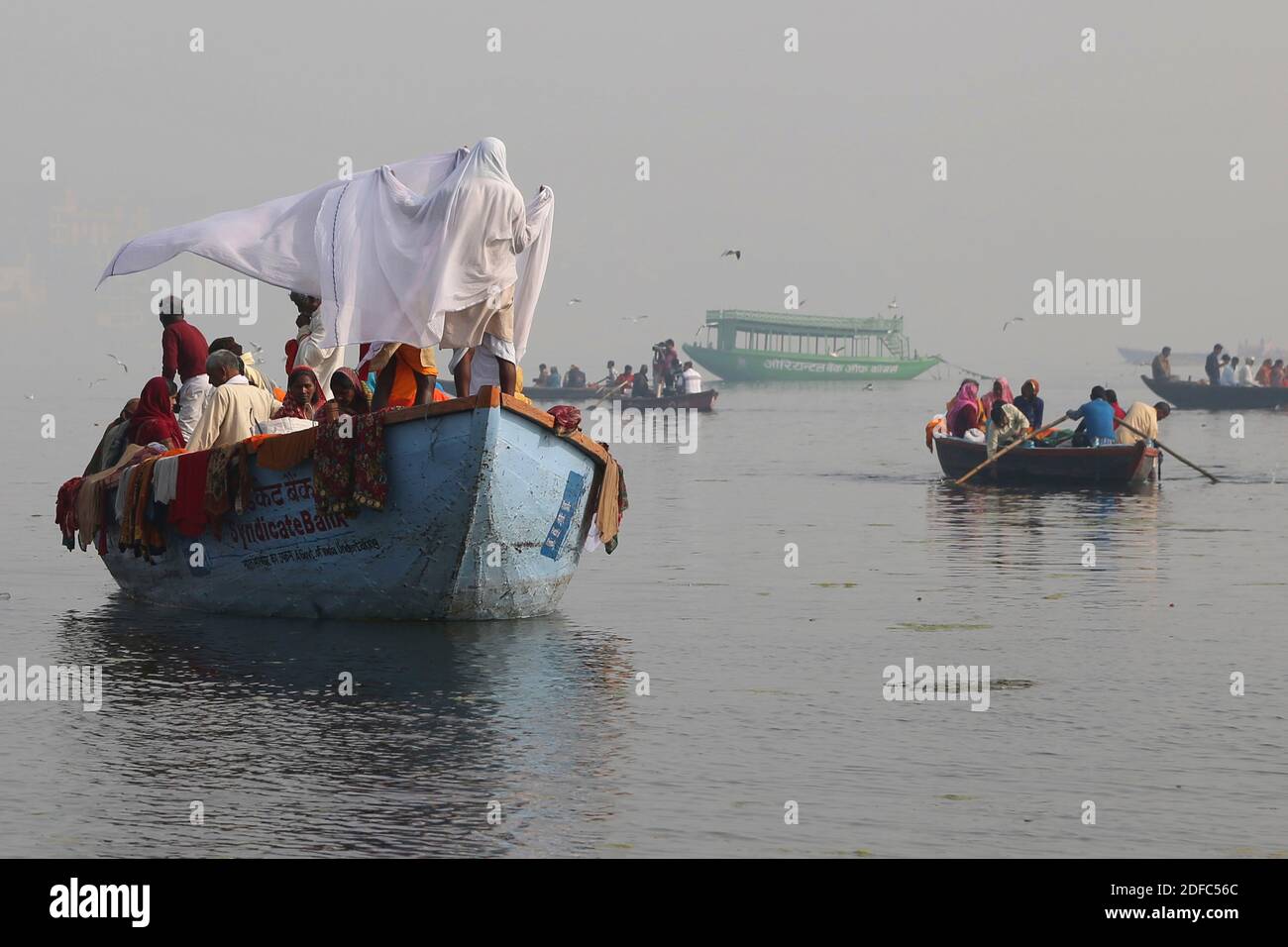 India, in the holy city of Varanasi, Hindu pilgrims on a boat on the ...