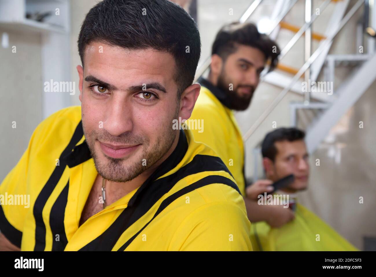 Iran, Isfahan, portrait of an Iranian man working in a barber shop ...