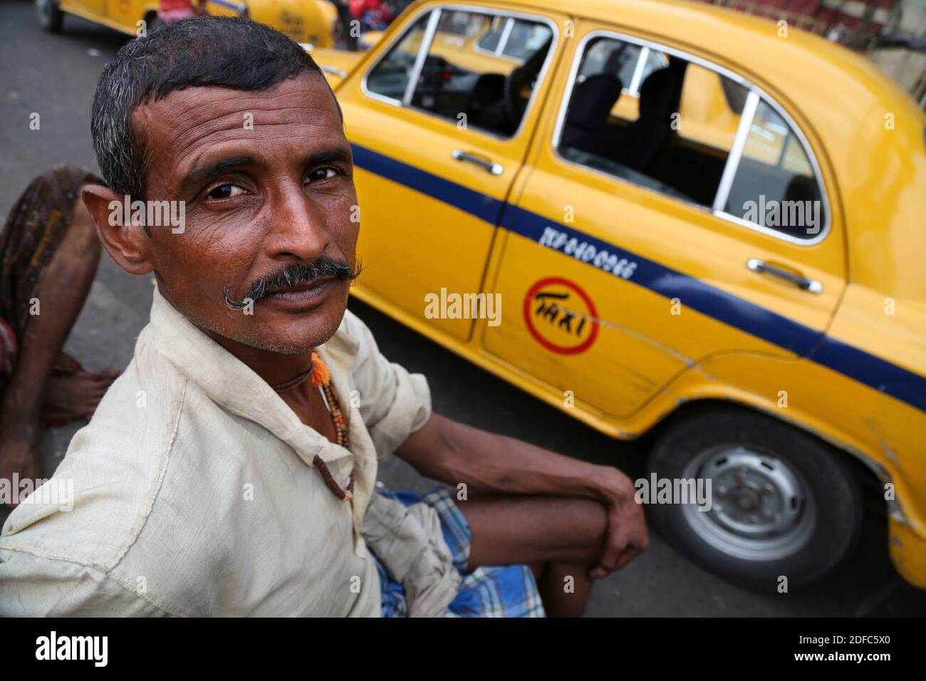 India, Kolkata, portrait of Bengali taxi driver waiting for customers ...