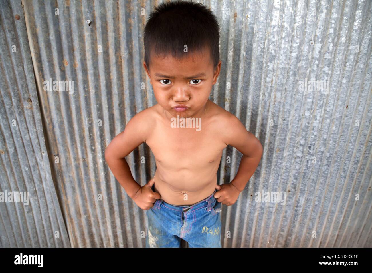 Cambodia, cute scowling kid in Kampot Stock Photo - Alamy