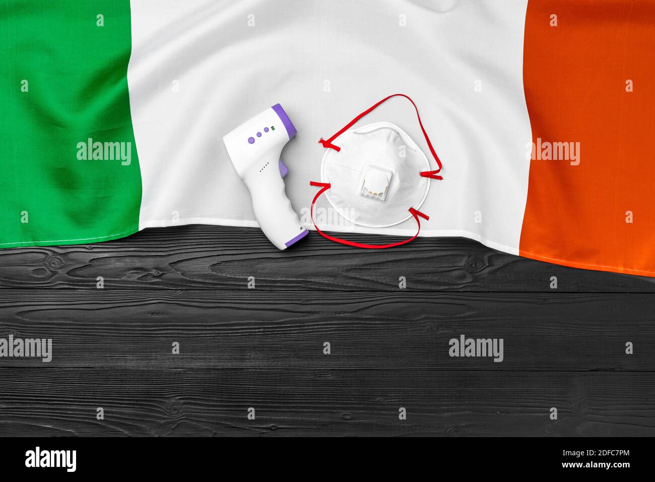 Medical face mask and contactless thermometer on flag of Italy Stock ...