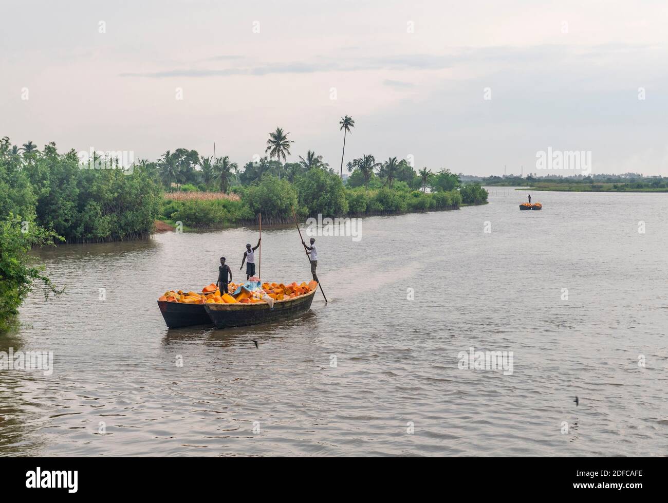 Togo, Agbodrafo, Mono river, boatmen carrying gasoline Stock Photo - Alamy