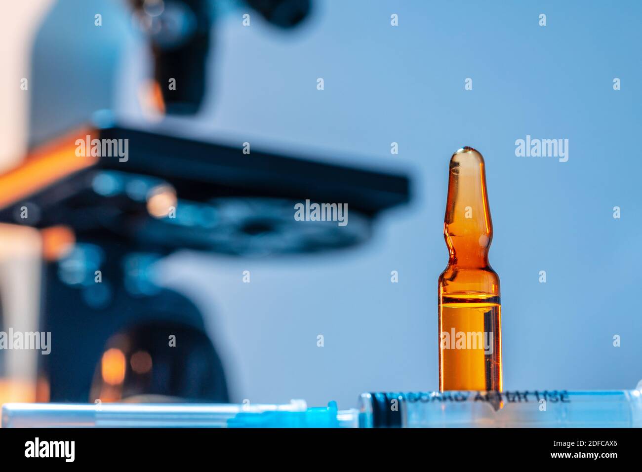 Medical vial with medication near microscope photo Stock Photo - Alamy