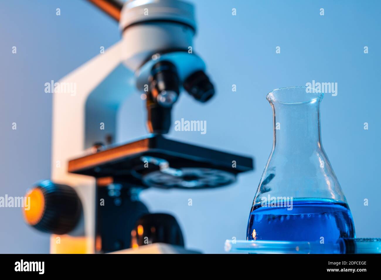 Medical vial with medication near microscope photo Stock Photo - Alamy