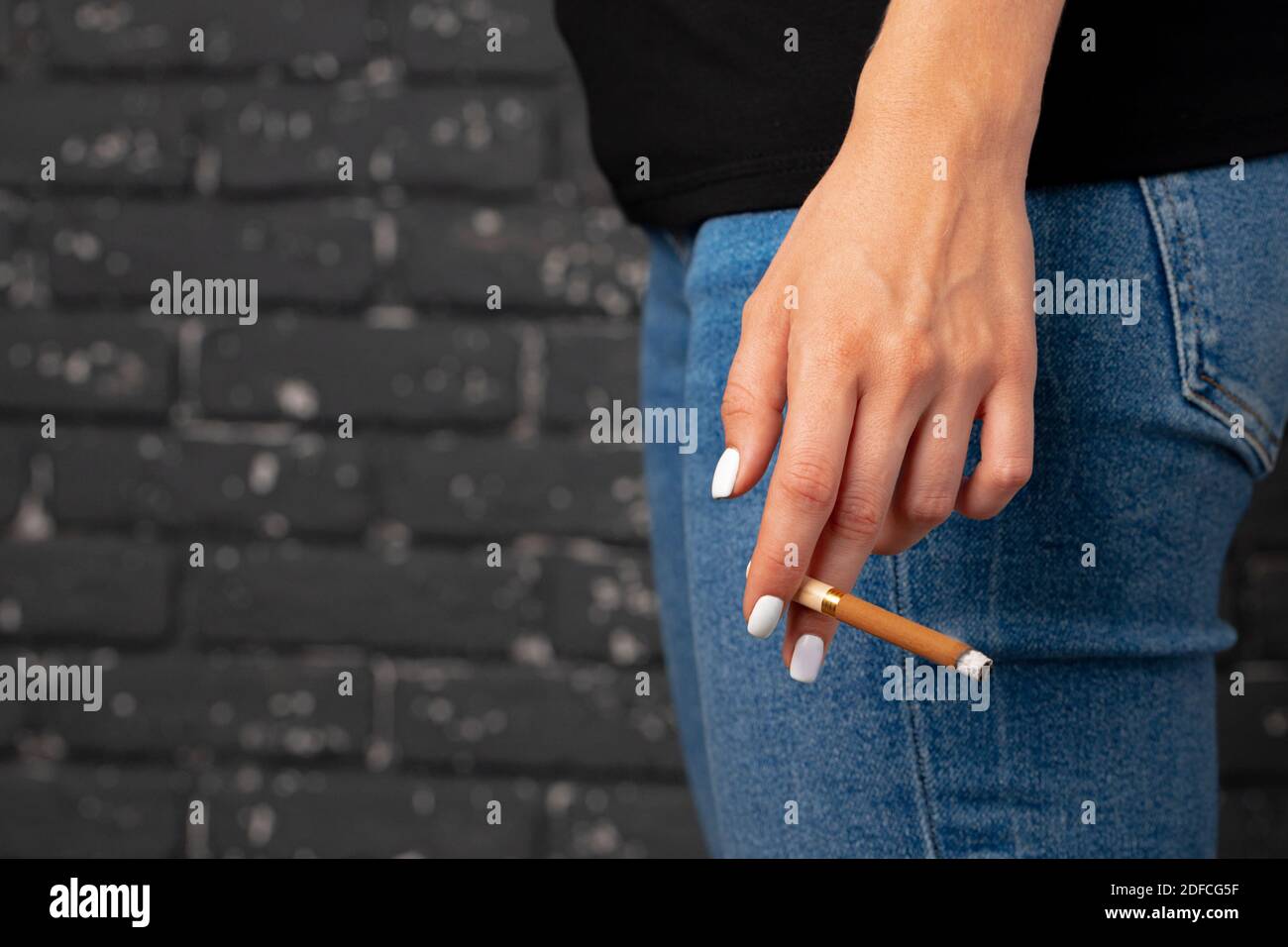Female hand holding lighted cigarette close up Stock Photo - Alamy