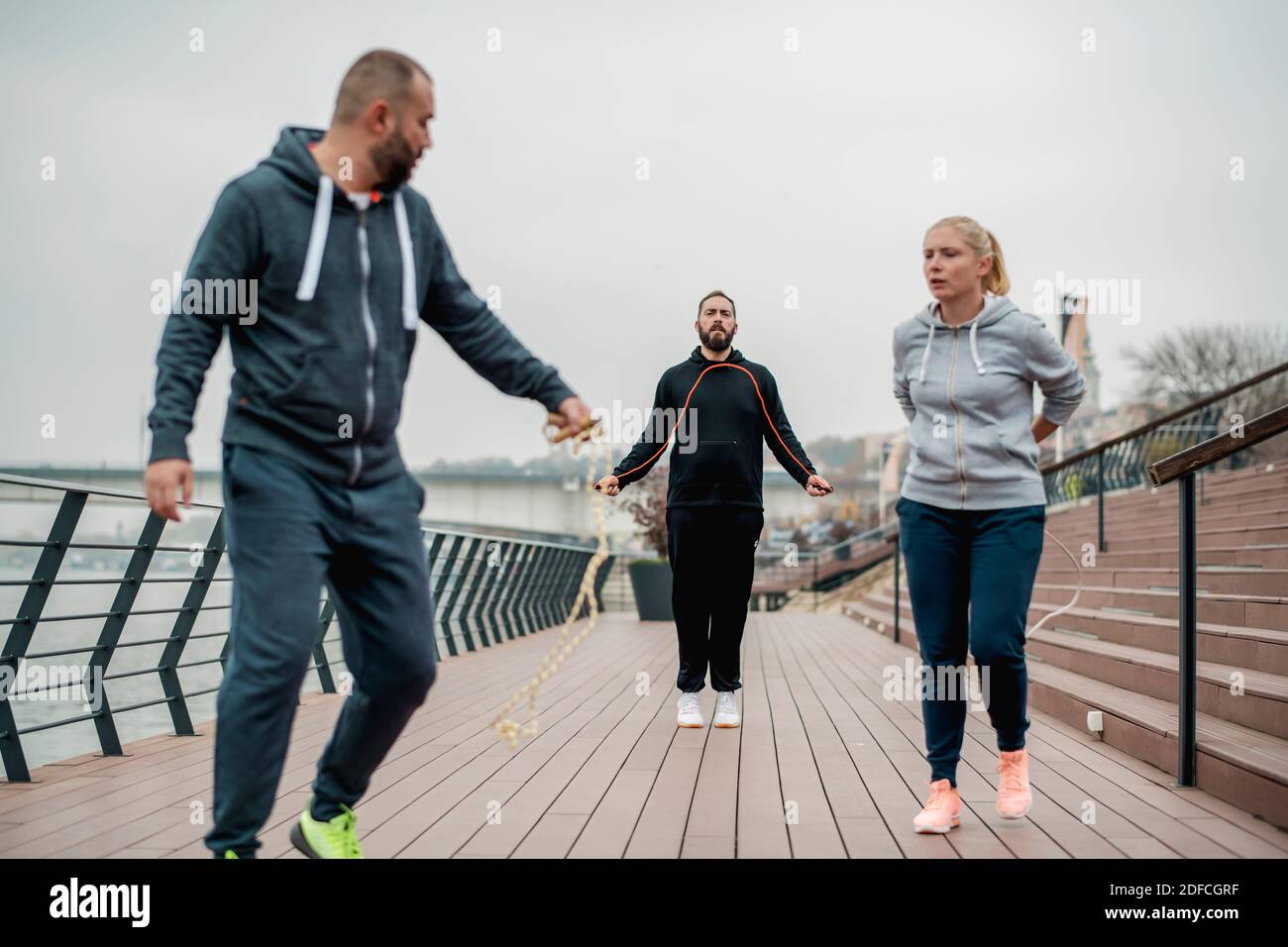Group of friends doing fitness exercise outdoor Stock Photo - Alamy