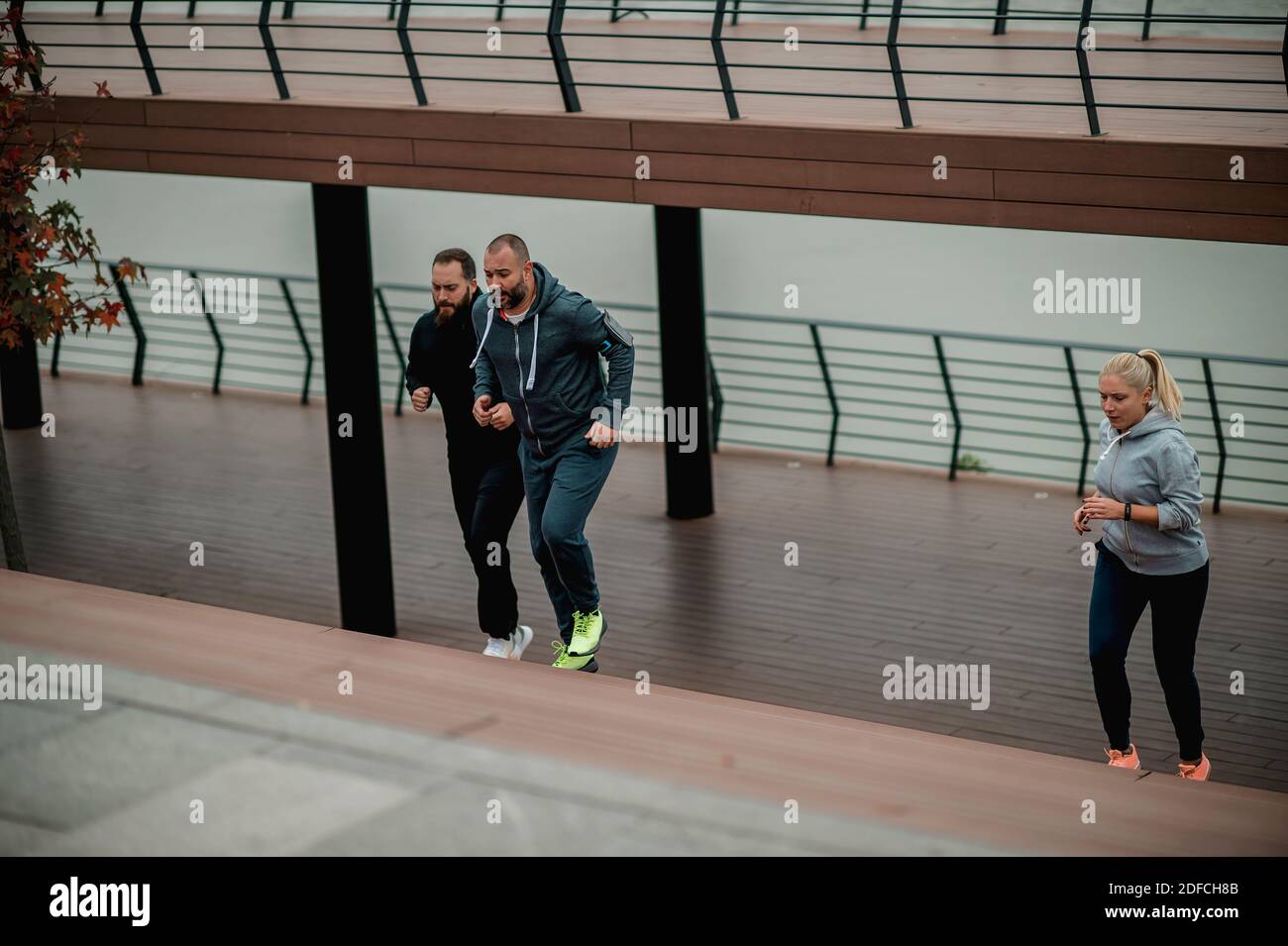 Three running men hi-res stock photography and images - Alamy
