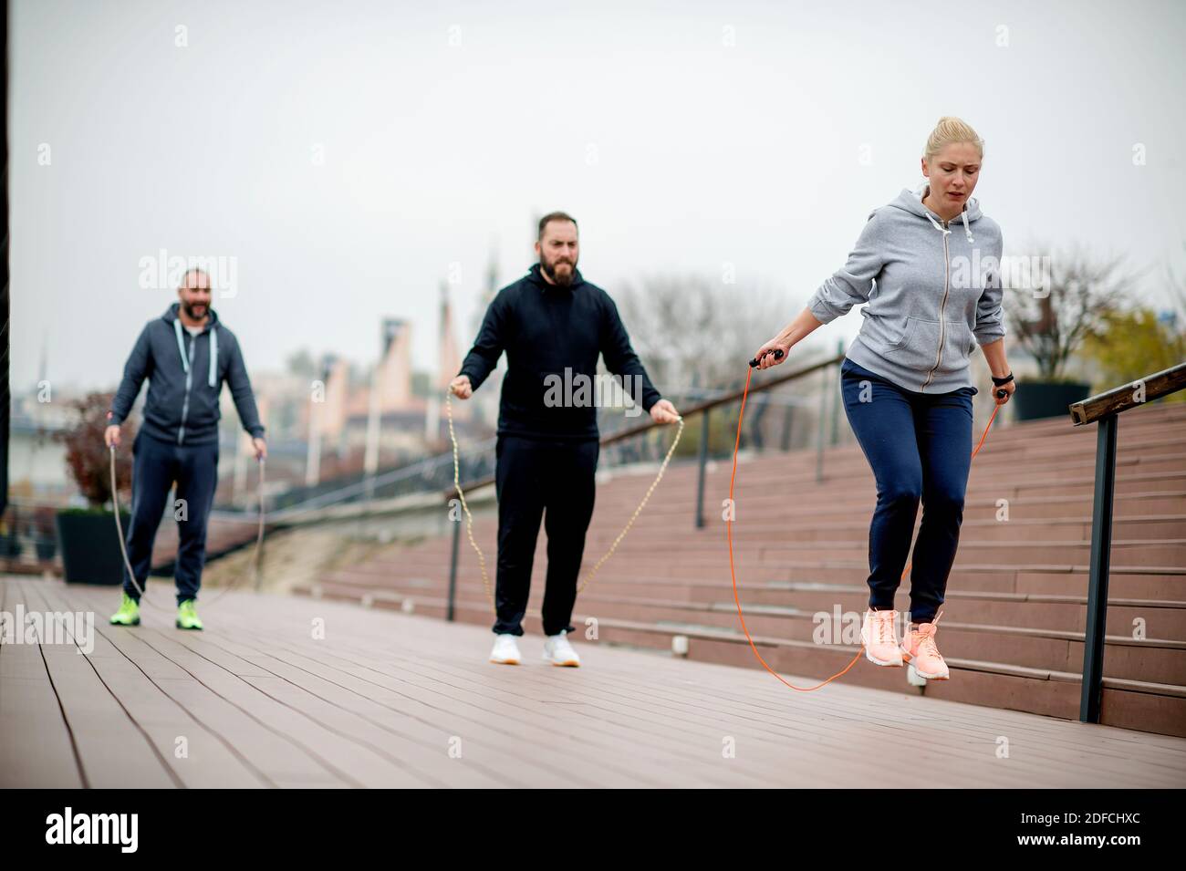 Group of friends doing fitness exercise outdoor Stock Photo - Alamy