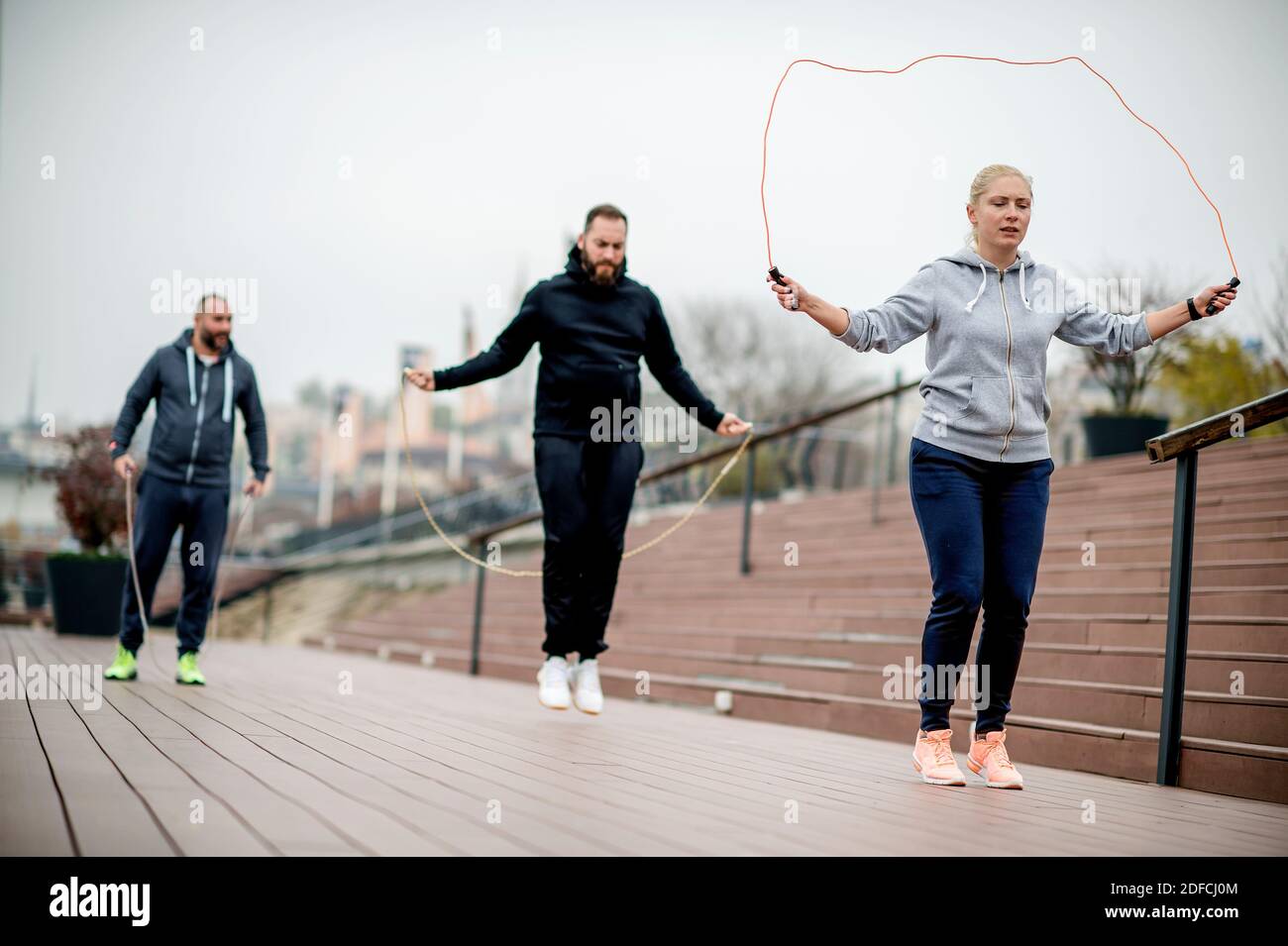 Group of friends doing fitness exercise outdoor Stock Photo - Alamy
