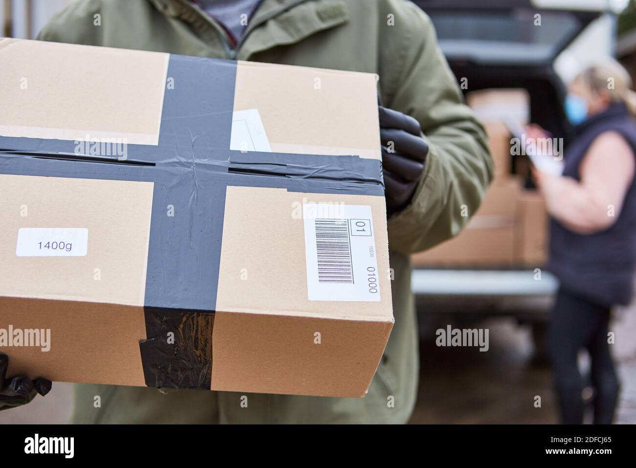 Parcel delivery is held in the camera by delivery service parcel ...