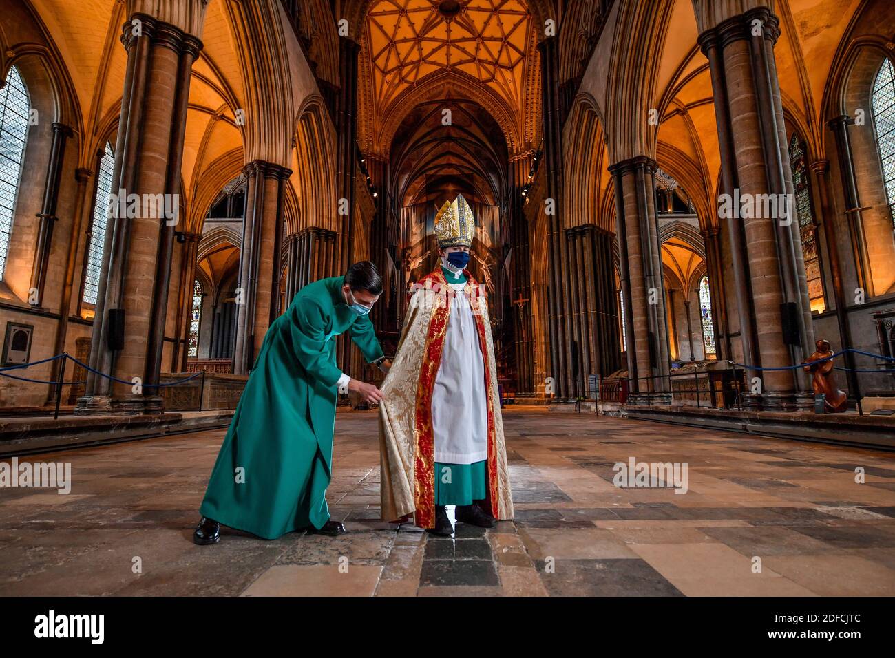 Verger Joseph Davies helps chorister Sebastian Kunzer, 13, to dress and ...
