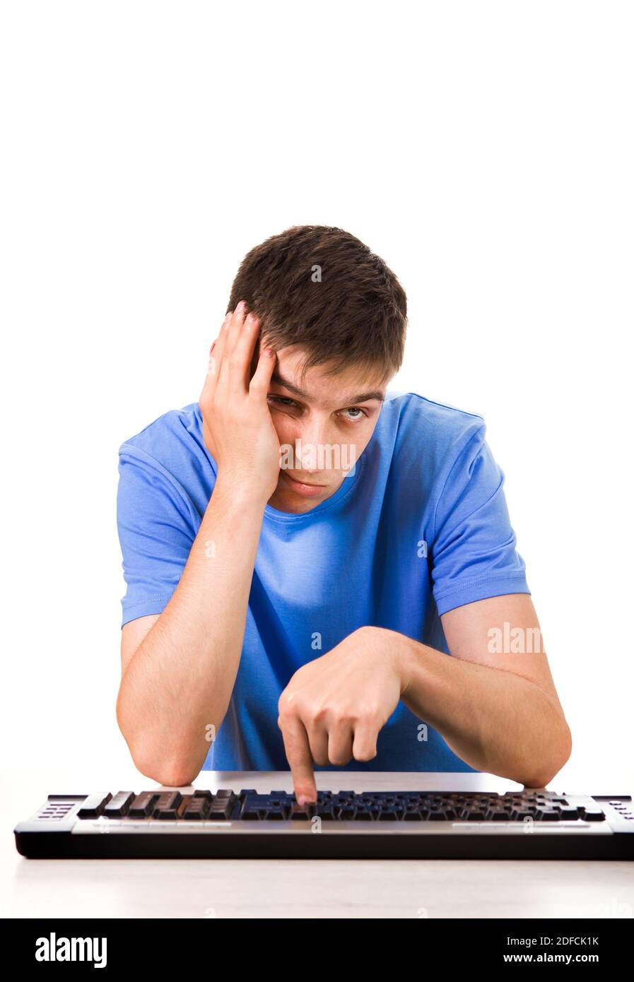 Bored Young Man with a Computer Keyboard on the White Background Stock ...