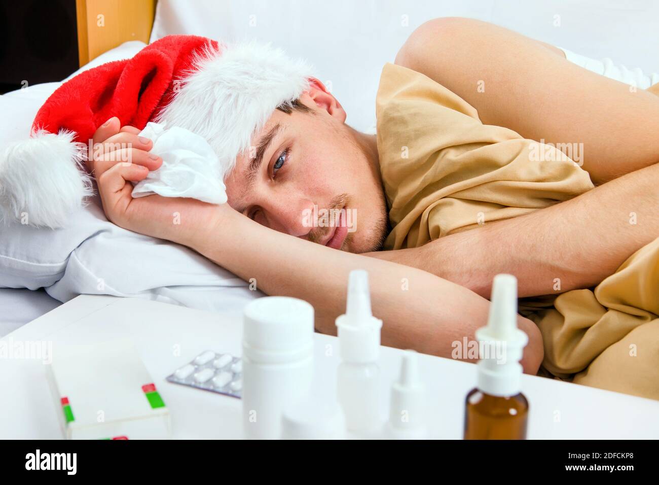 Sick Man in Santa Hat in the Bed at the Home Stock Photo - Alamy