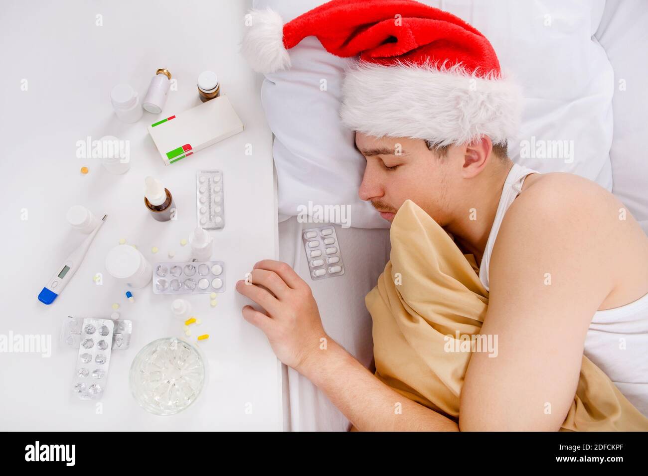 Sick Man in Santa Hat sleep in the Bed Stock Photo - Alamy