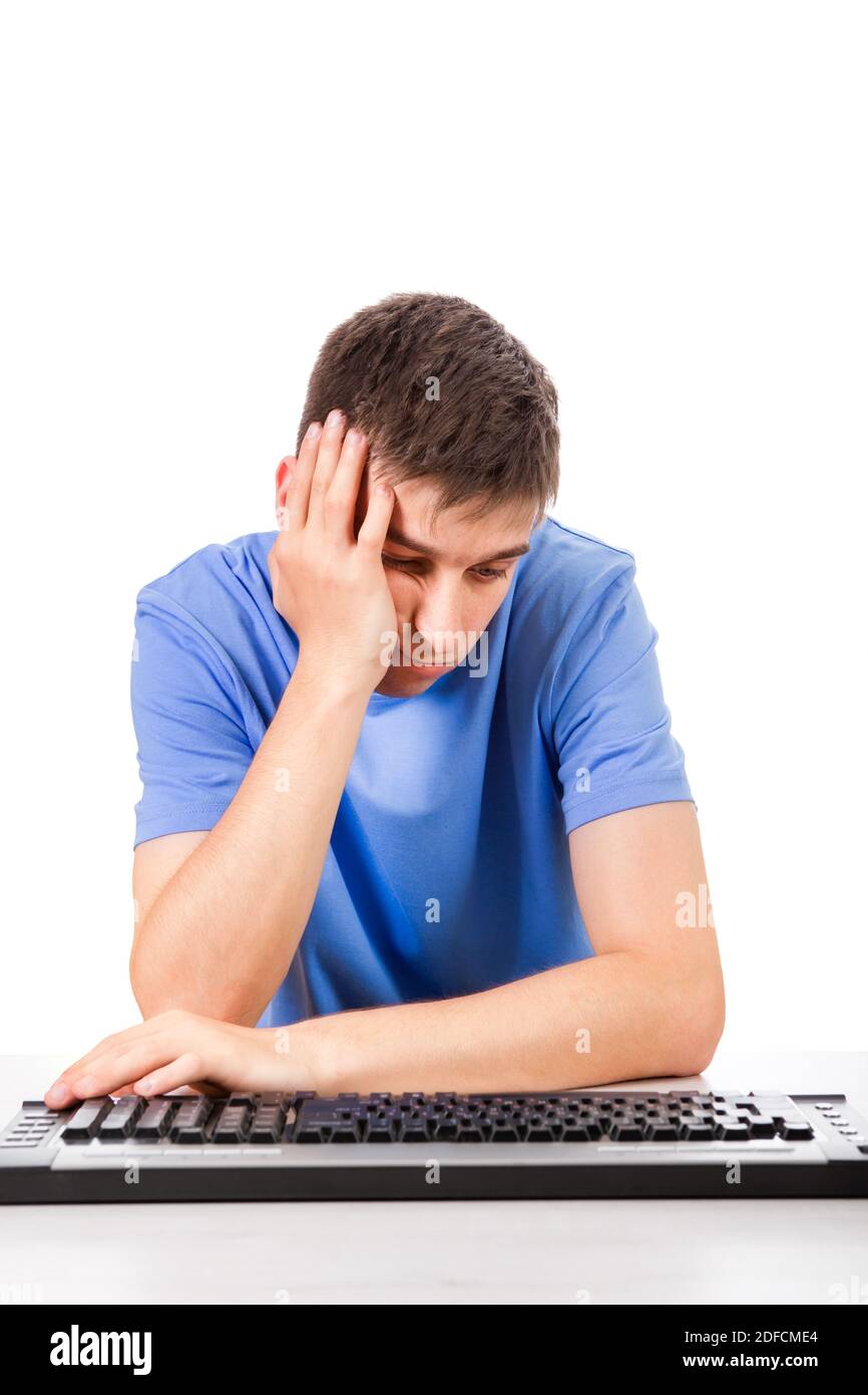 Bored Young Man with a Computer Keyboard on the White Background Stock ...