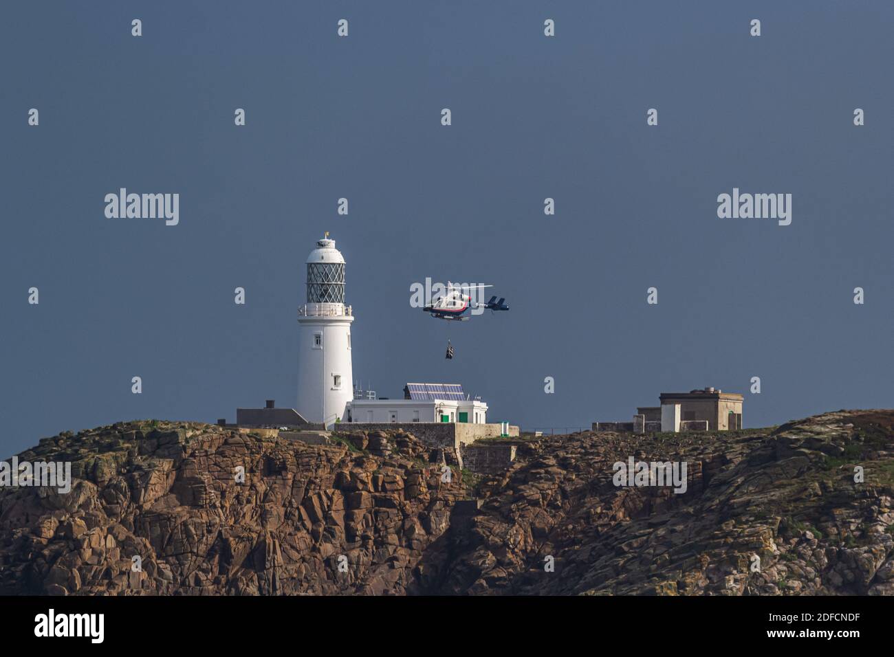 Helicopter delivering material to Round Island Lighthouse Stock Photo ...