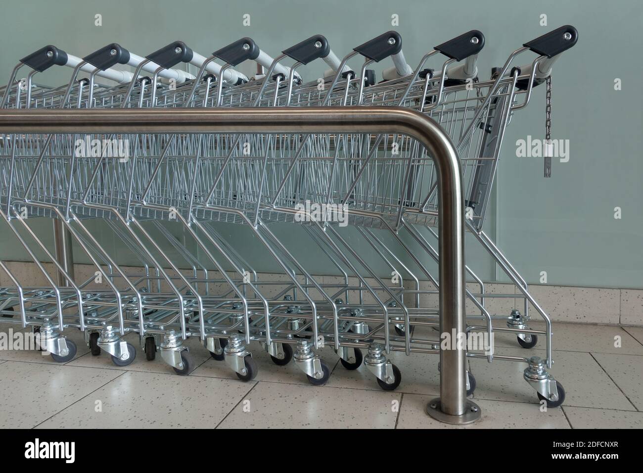 Shopping carts pushed into each other in a row Stock Photo - Alamy