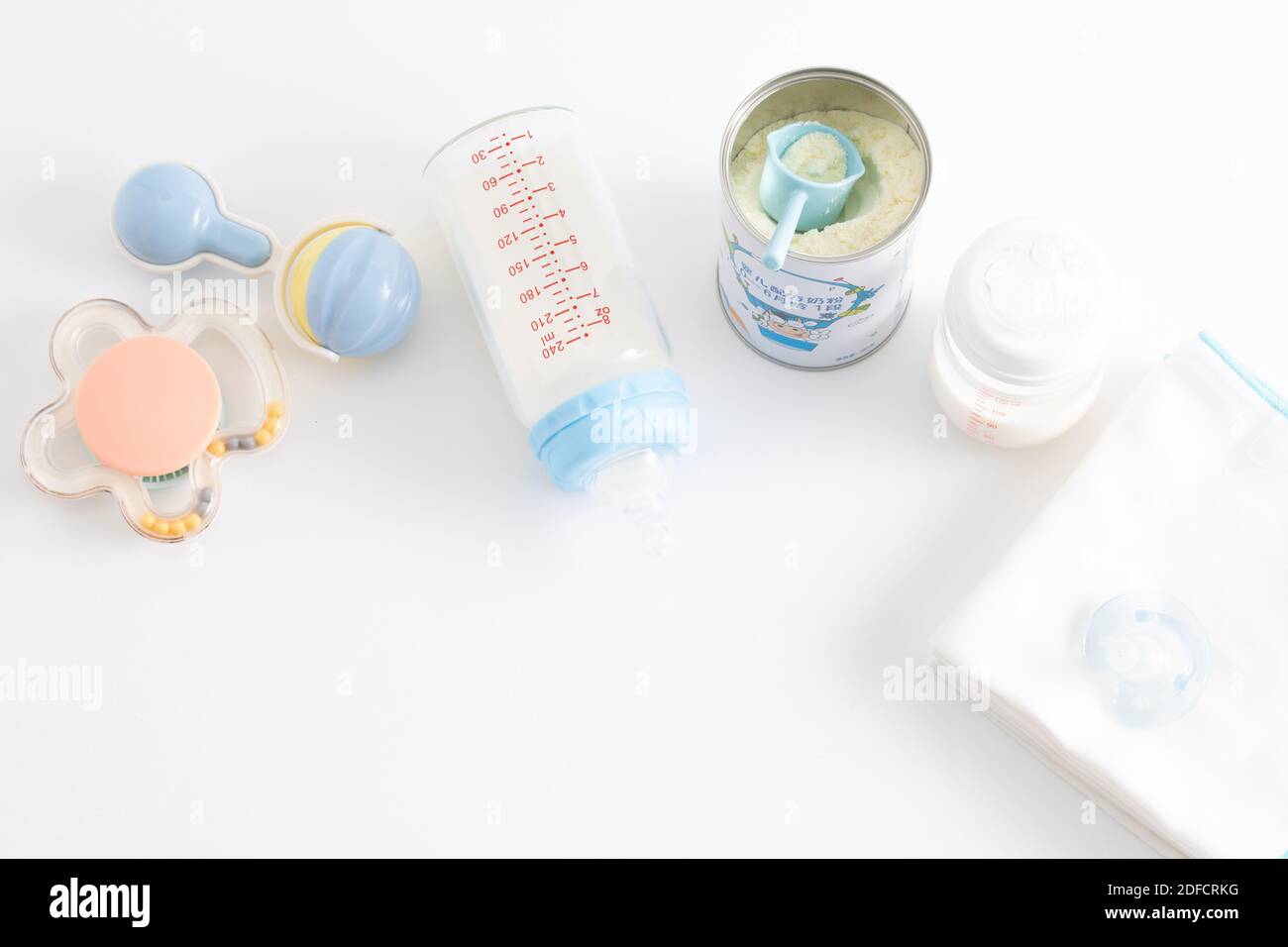 A top view shot of feeding bottles, baby food, baby rattle, pacifier ...
