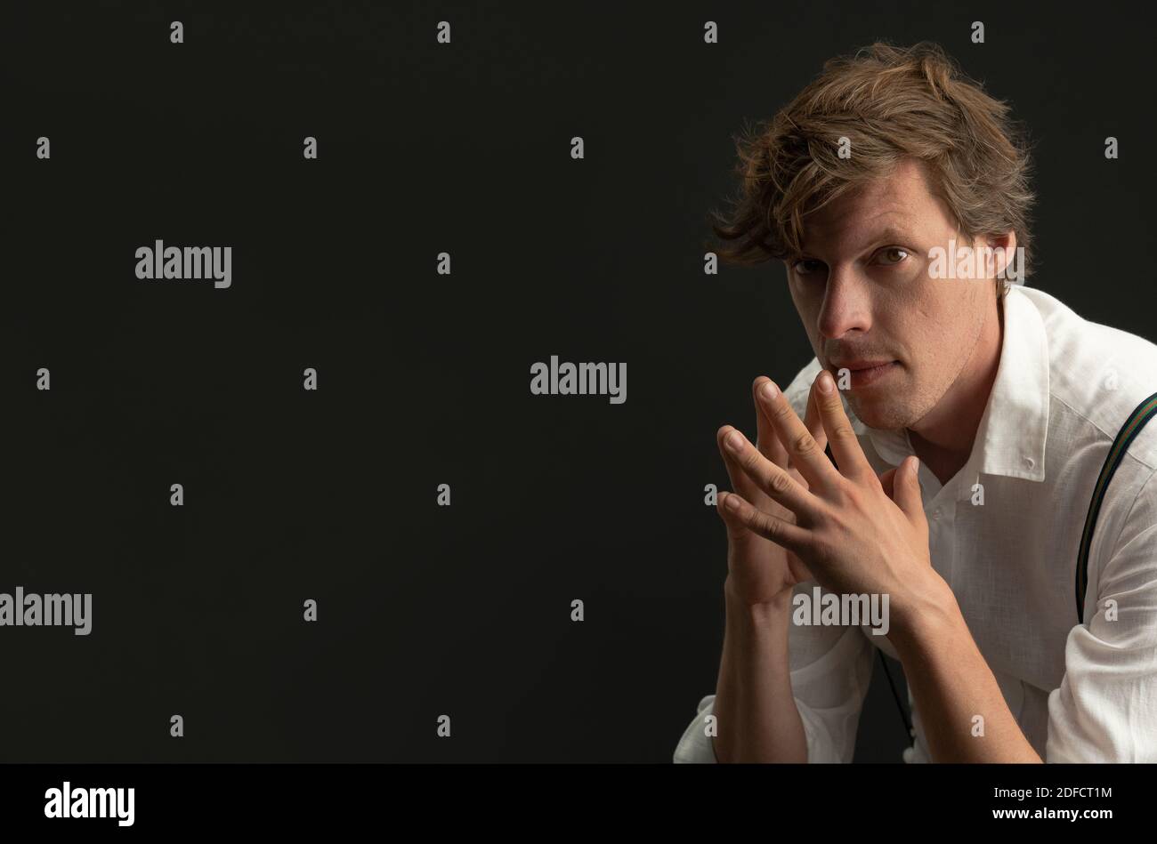 Confident freelancer overthinking ideas with fingertips folded in front ...