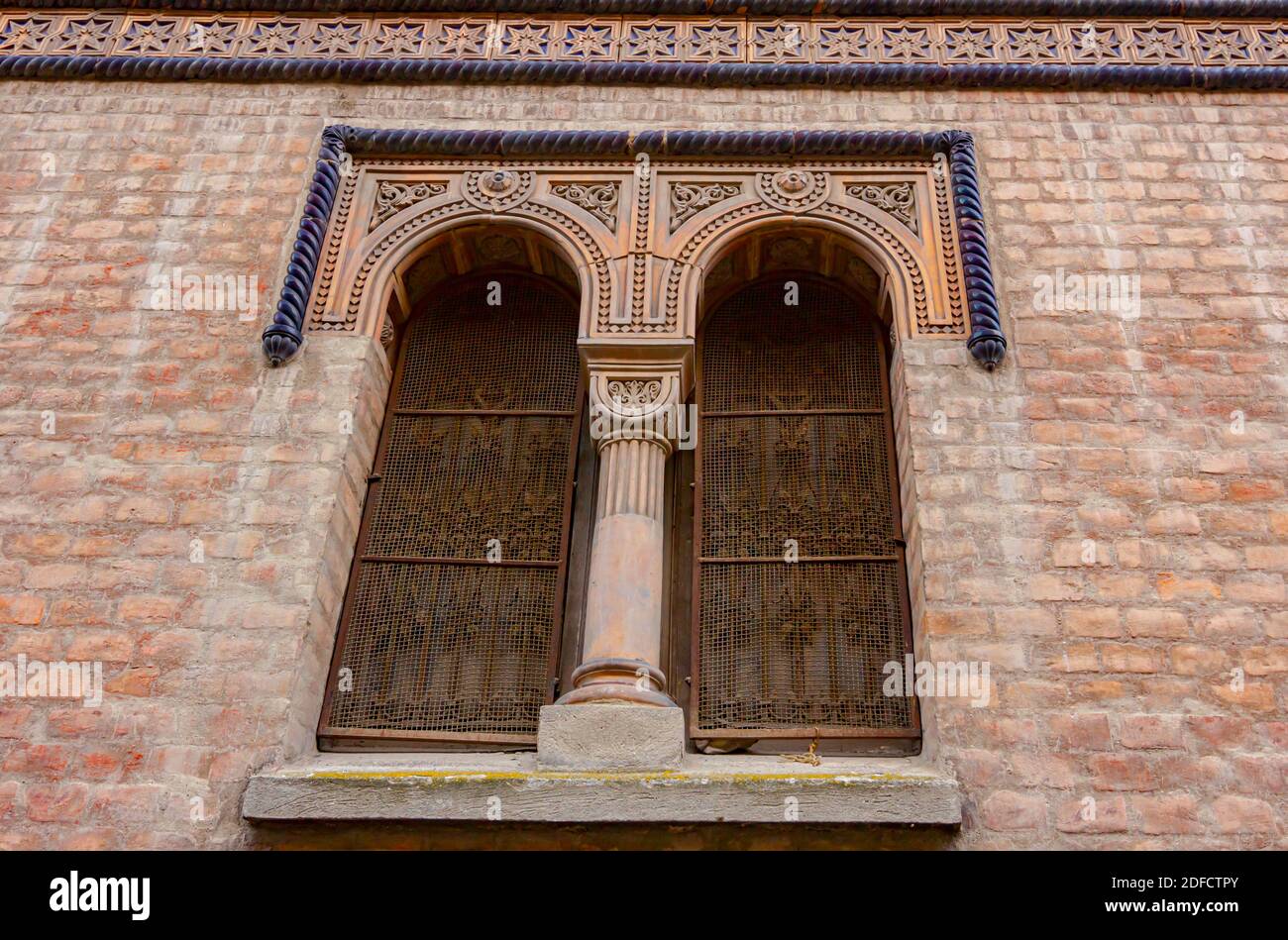 Closed windows with ornaments on facade made of decorative bricks ...