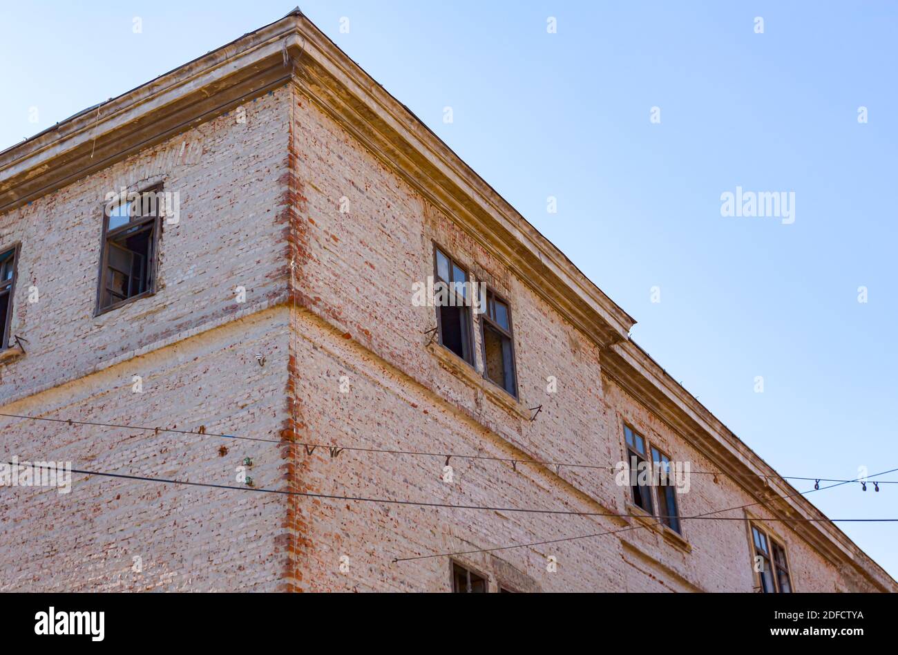 Bottom side view on damaged facade of building with bricks and broken ...
