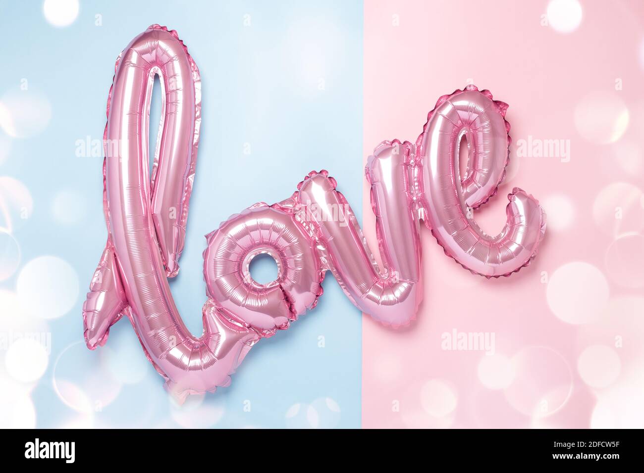 Pink balloons in the form of word Love on pink and blue background ...