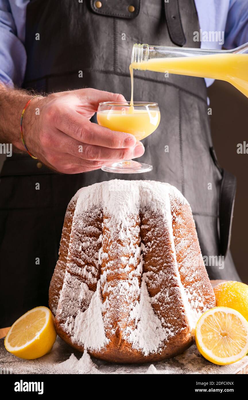 Lemon cremoncello. Man holds a glass of limoncello in his hands, and a ...