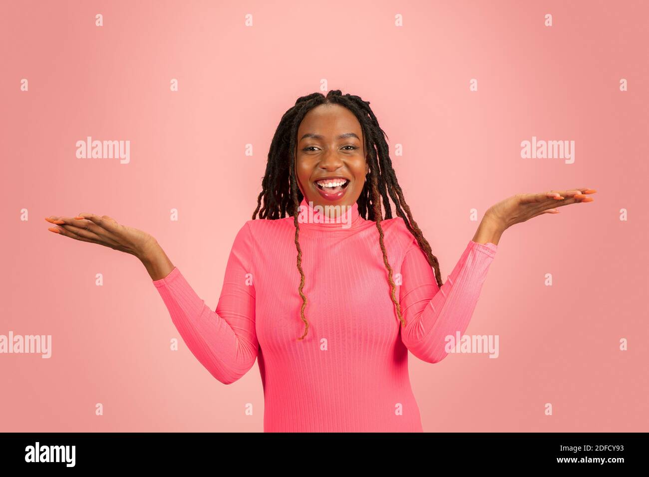 Happiness. Young african-american woman's portrait isolated on pink ...
