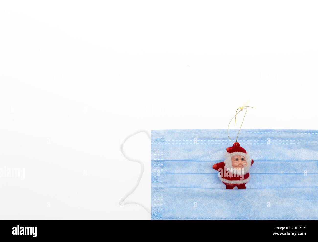 Santa claus miniature with surgical face mask isolated on white ...
