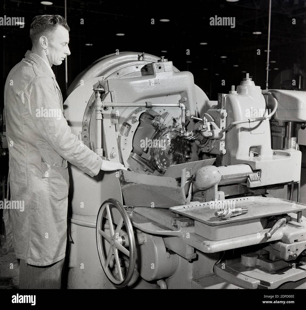 1950s, historical, an male operator standing overseeing the working of ...