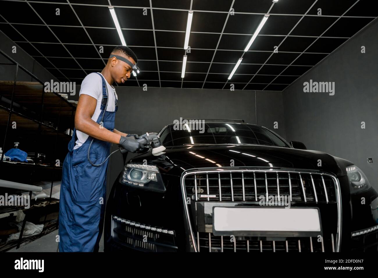 Car detailing series. Polishing of luxury black car at professional ...