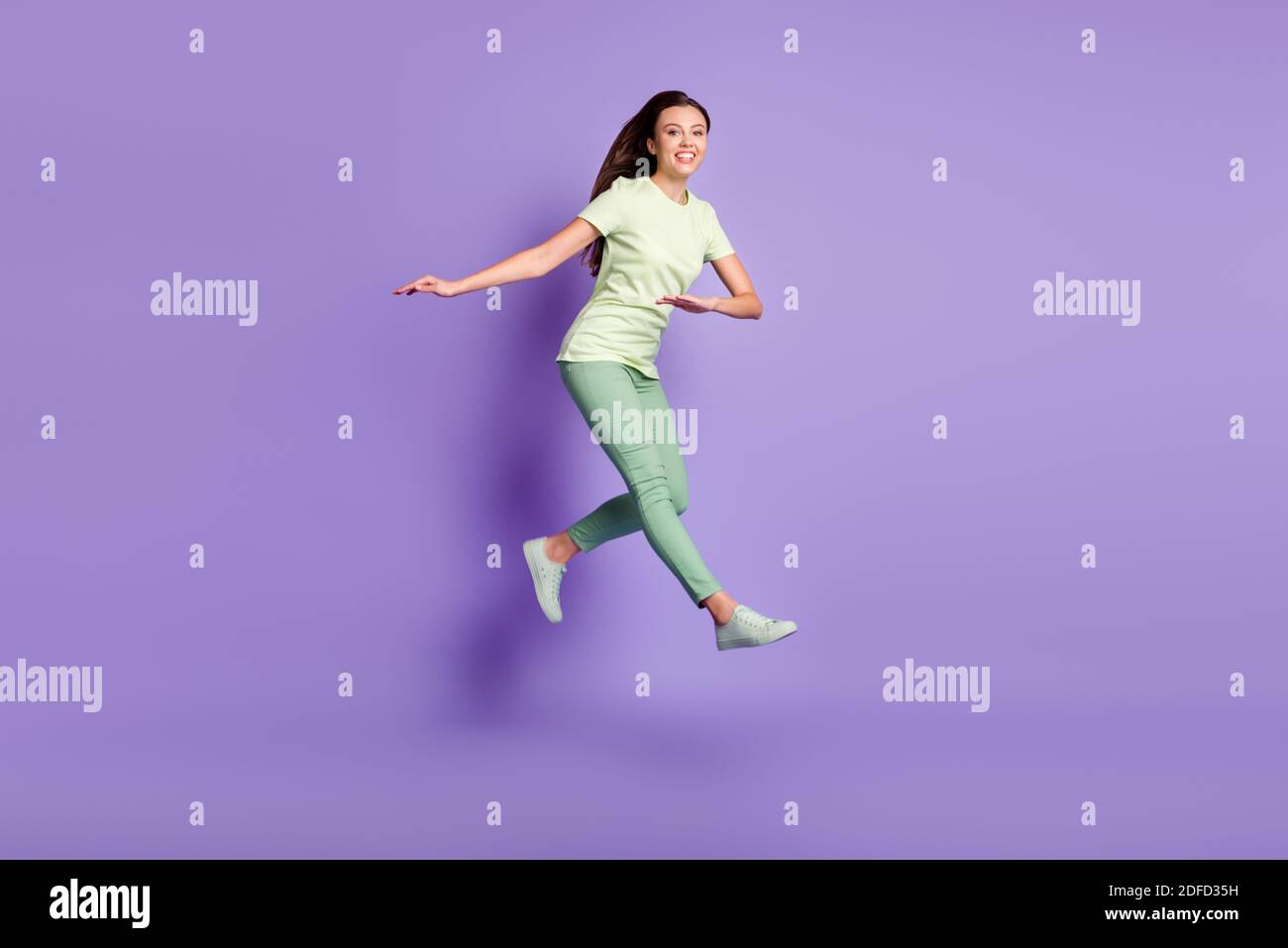 Full length portrait of attractive lady jump have fun toothy smile wear ...