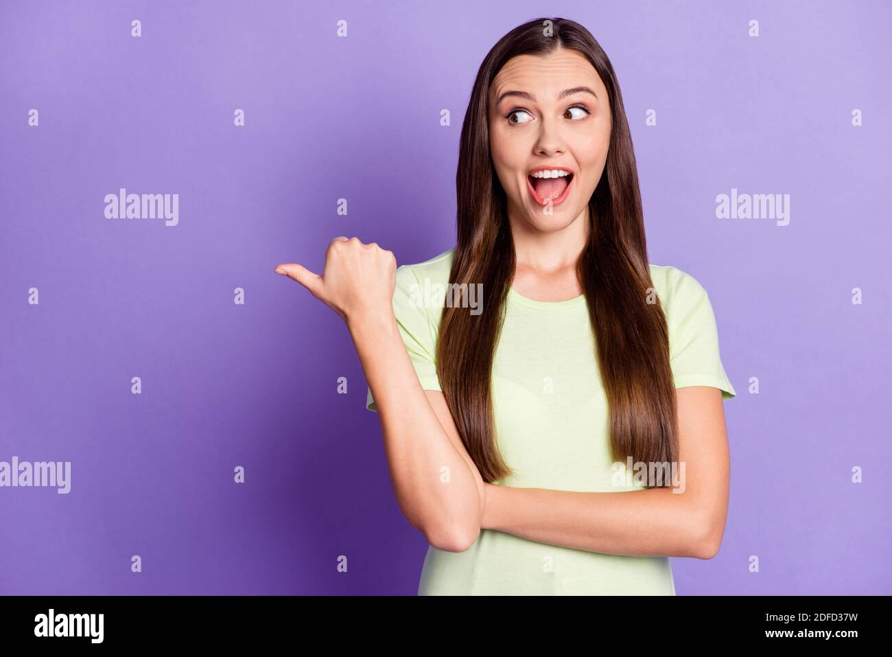Photo of impressed lady look direct thumb empty space open mouth ...