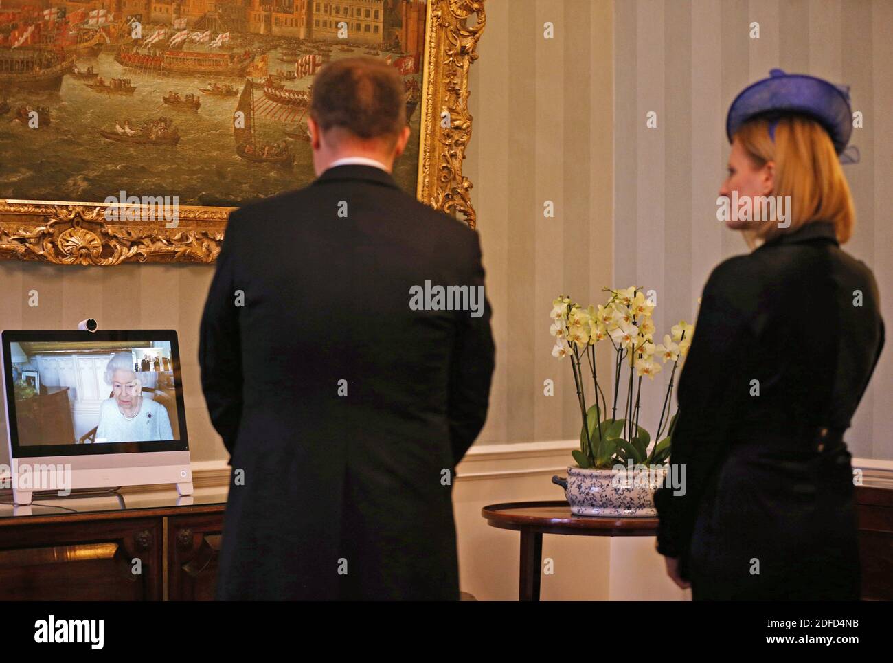 Queen Elizabeth II appears on a screen by videolink from Windsor Castle ...