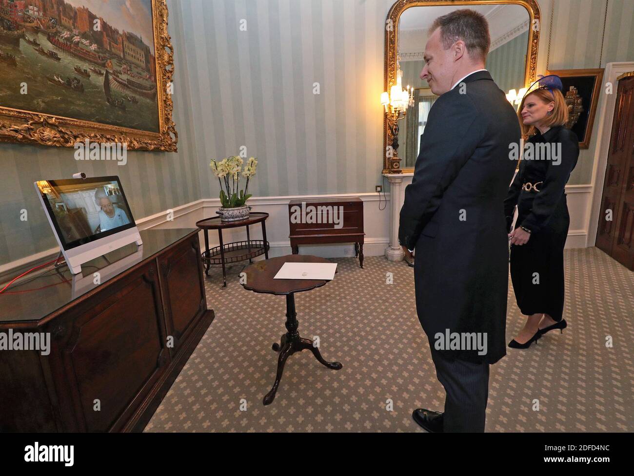 Queen Elizabeth II appears on a screen by videolink from Windsor Castle ...