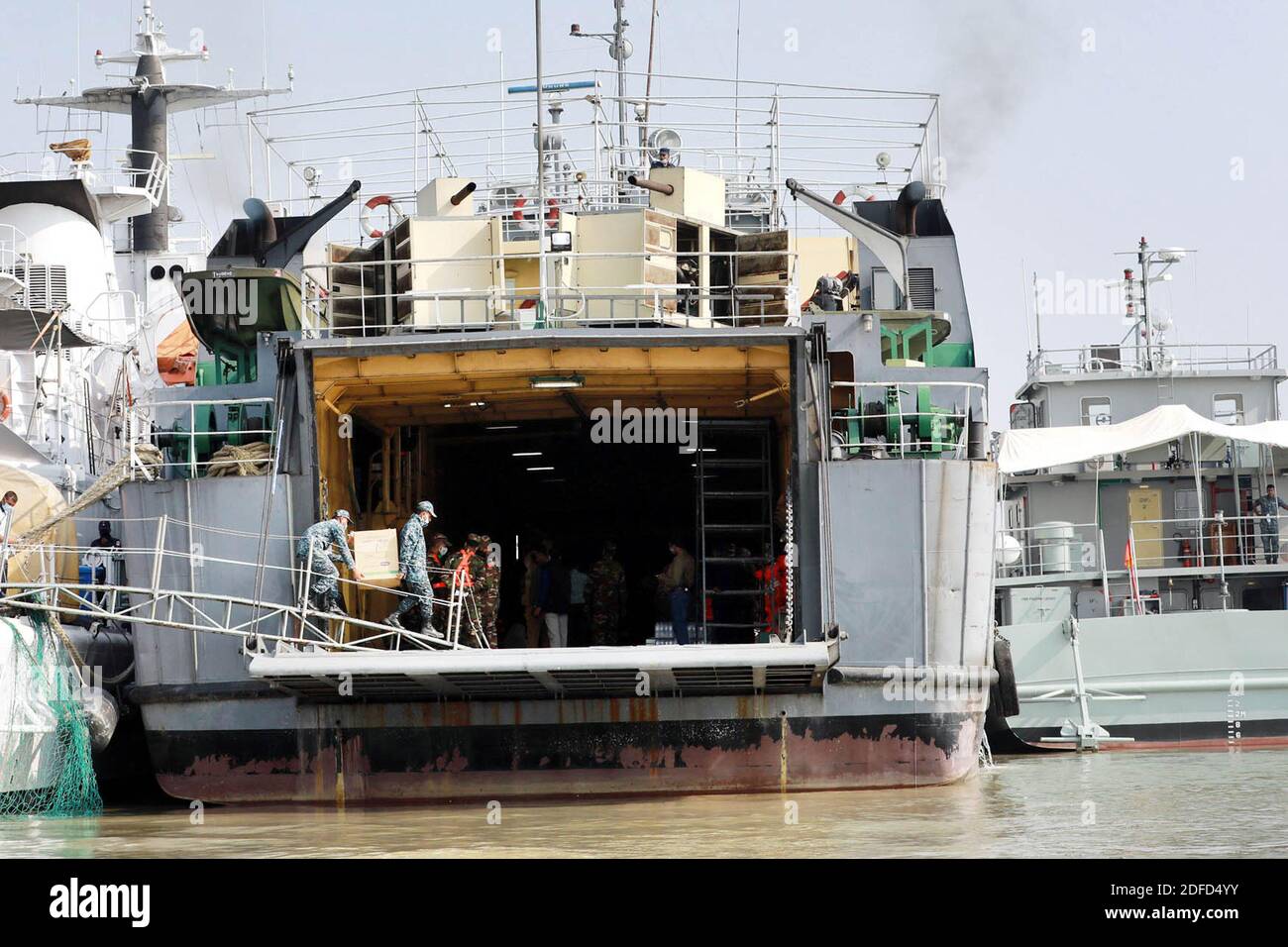 Rohingya refugees board a Bangladesh Navy ship to be transported to the ...