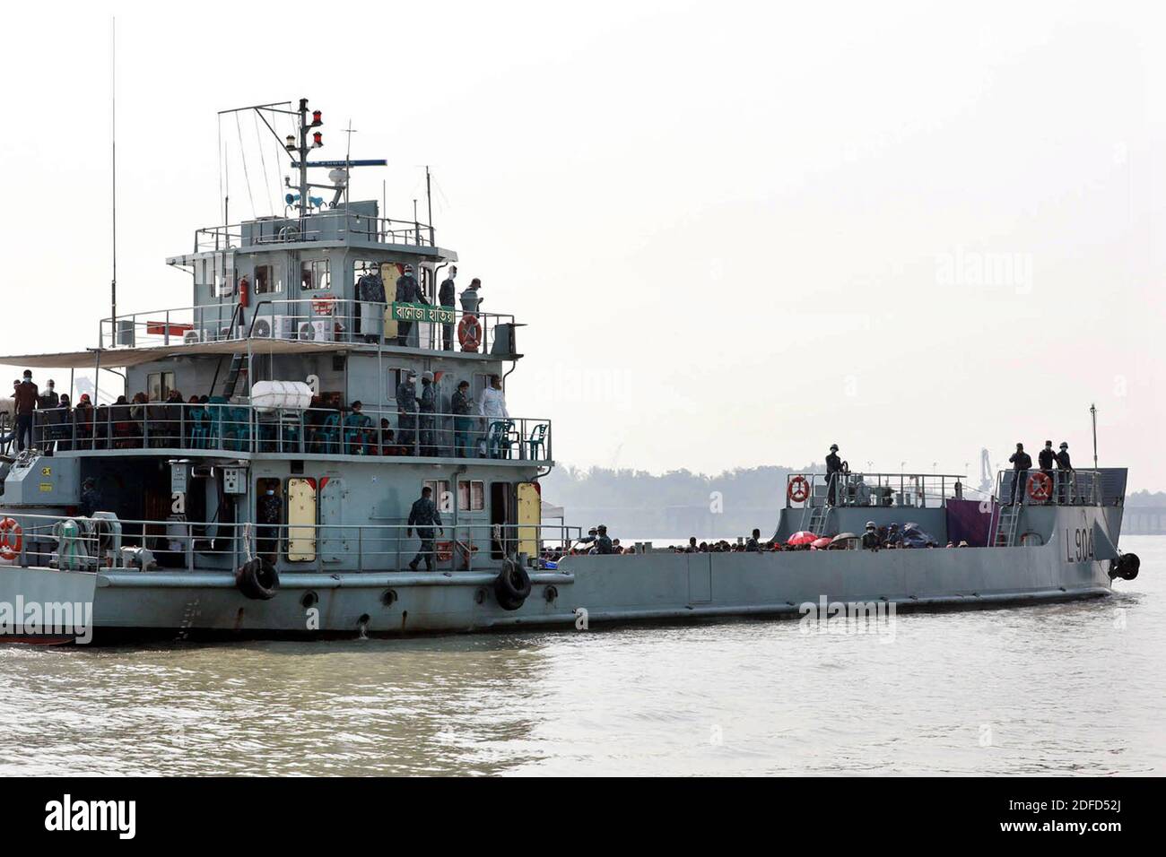 Rohingya refugees board a Bangladesh Navy ship to be transported to the ...