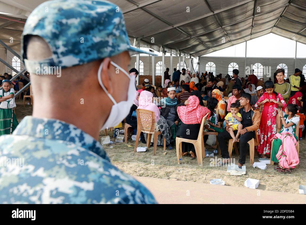Rohingya refugees wait to board a Bangladesh Navy ship to be ...
