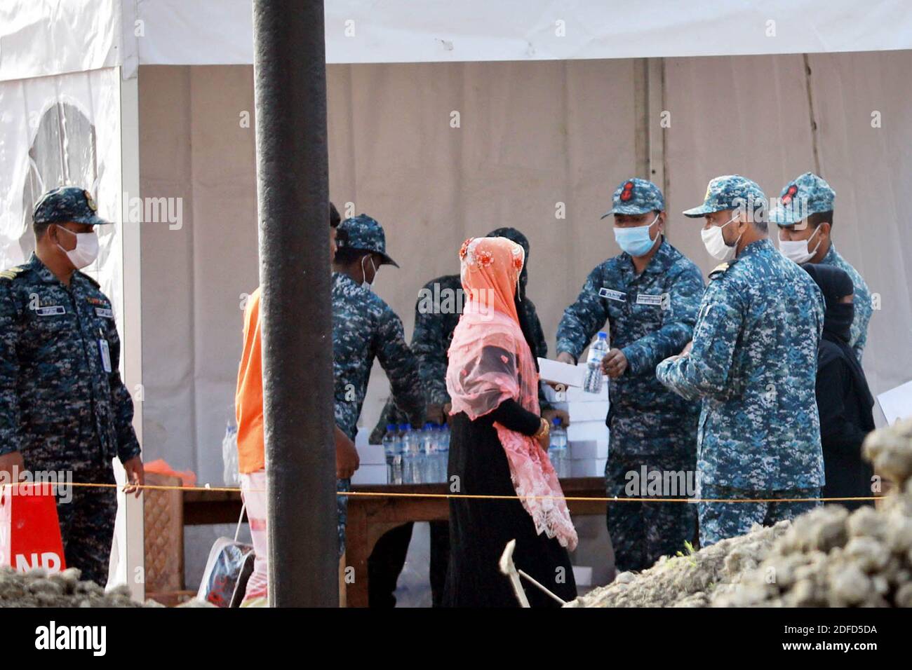 Rohingya refugees wait to board a Bangladesh Navy ship to be ...