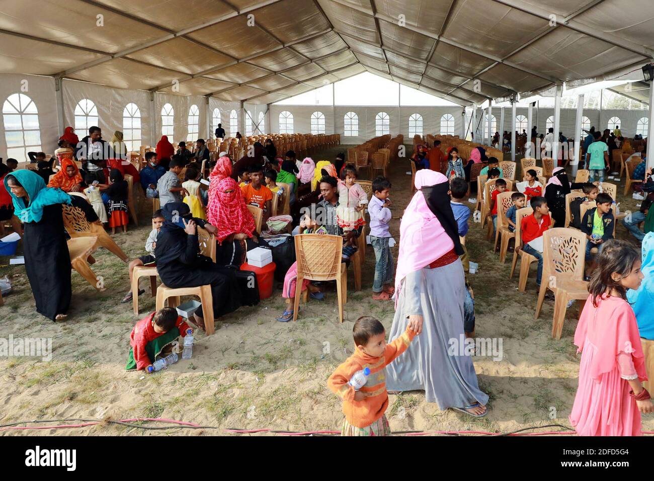 Rohingya refugees wait to board a Bangladesh Navy ship to be ...