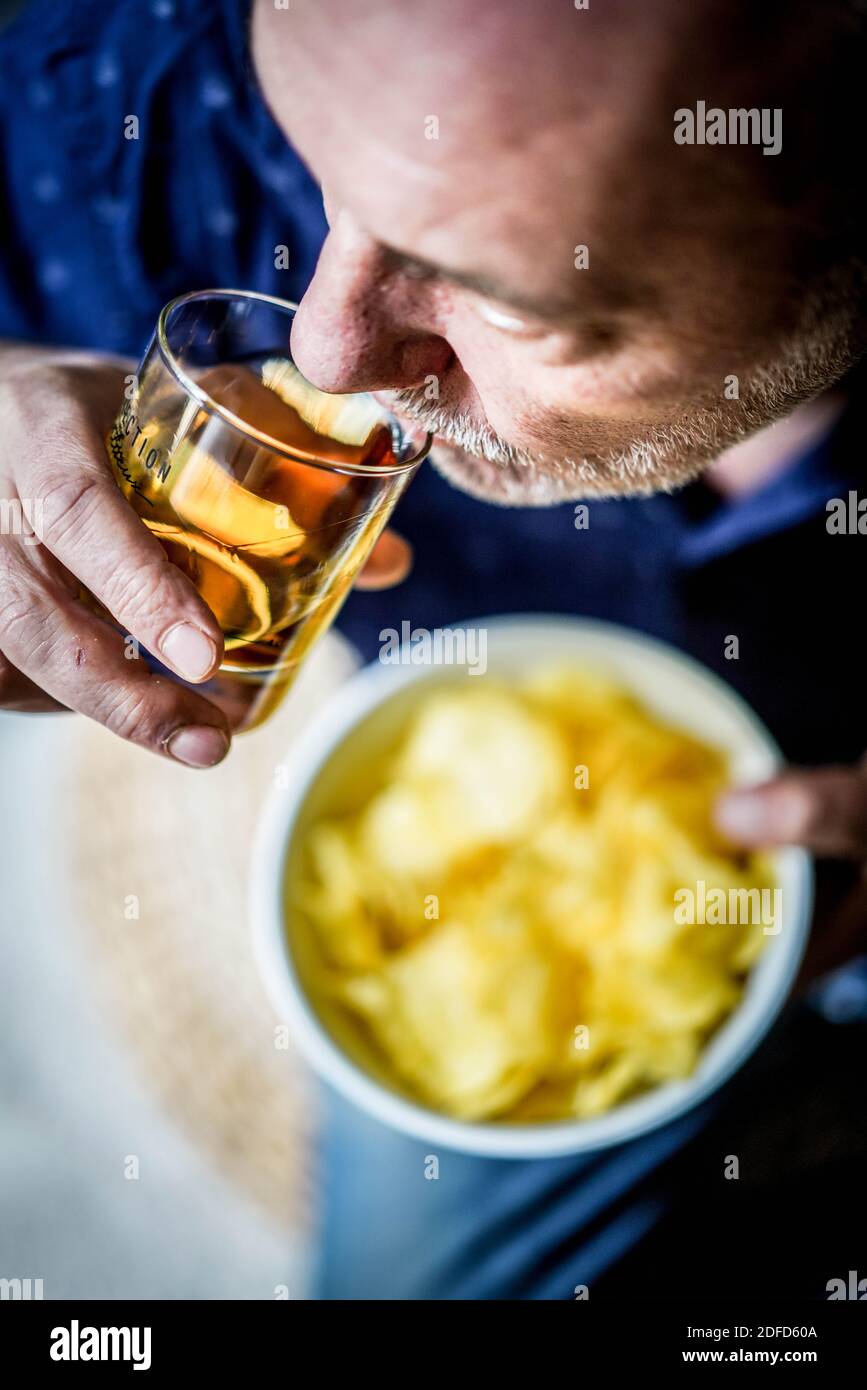 Man eating potato chips Stock Photo - Alamy