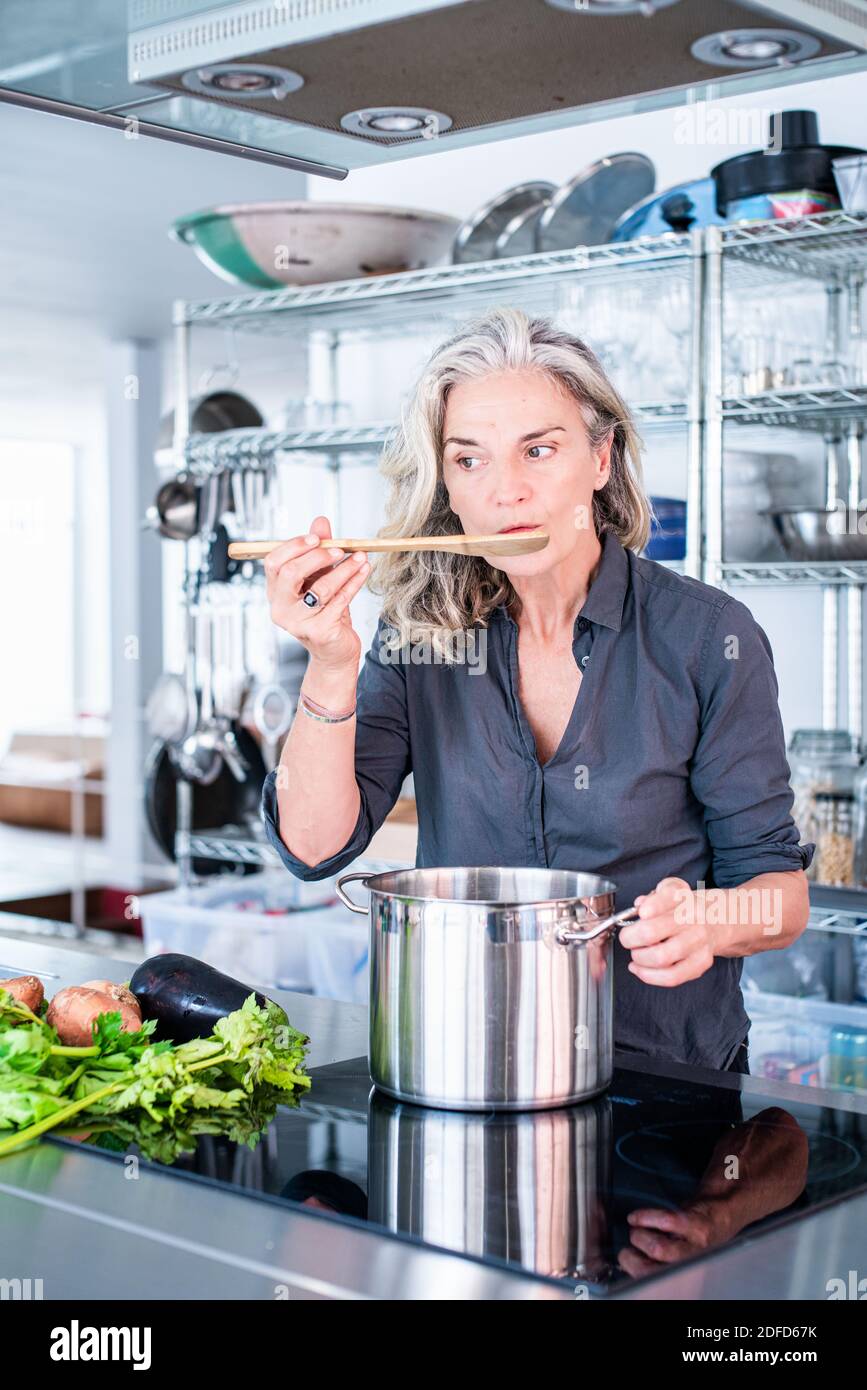 Woman cooking on an induction hob Stock Photo - Alamy