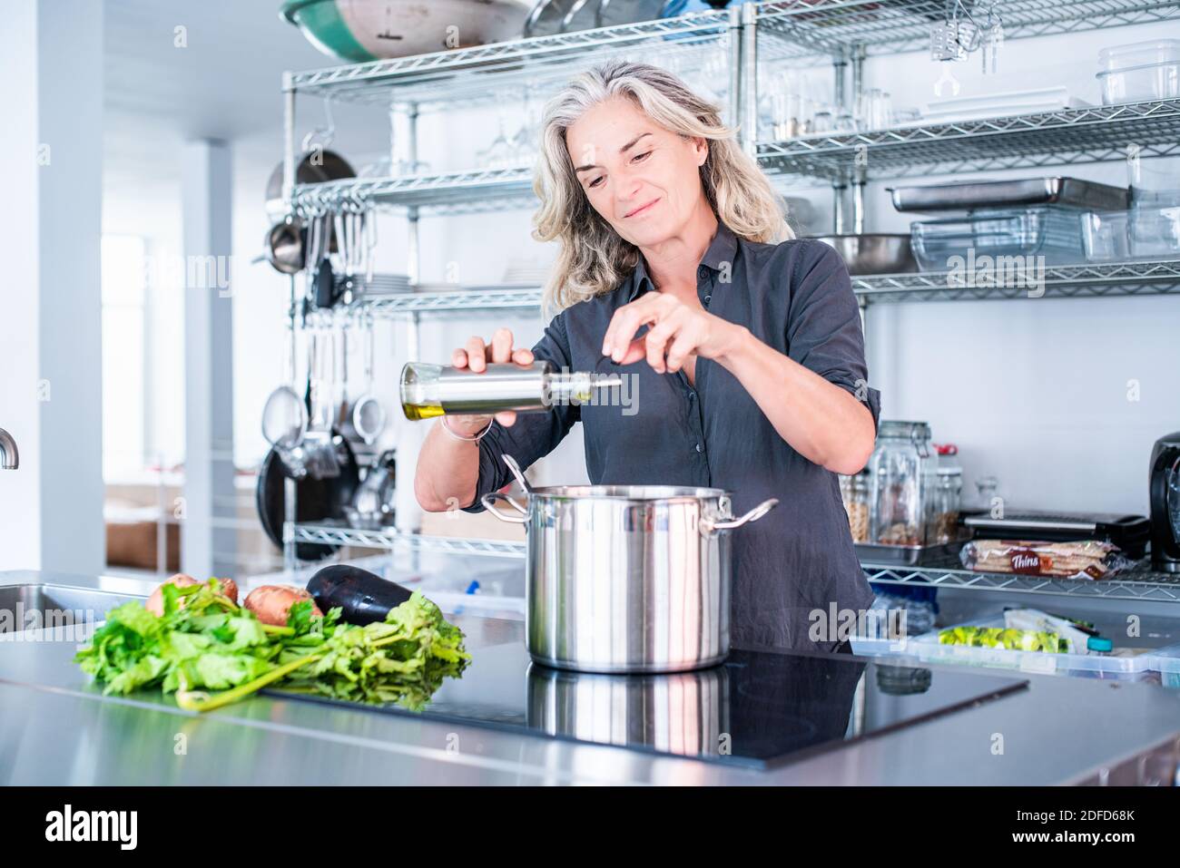 Woman cooking on an induction hob Stock Photo - Alamy