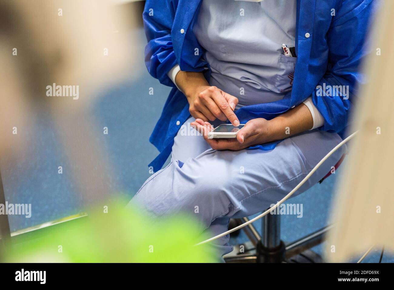 Nurse using a smartphone in an operating theater, France Stock Photo ...