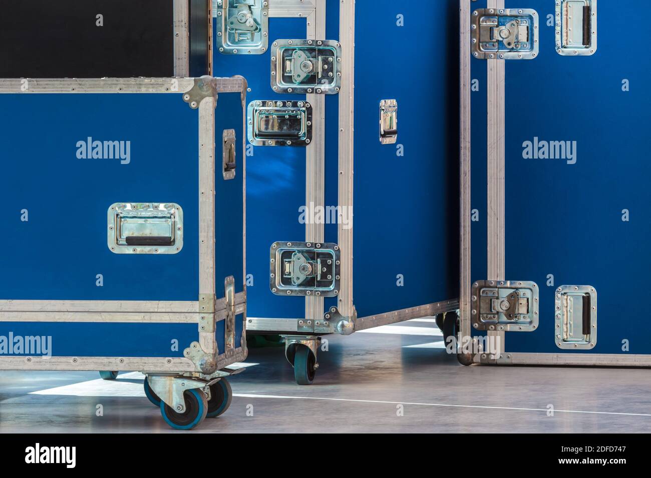 Group of blue flight cases on a grey floor Stock Photo - Alamy