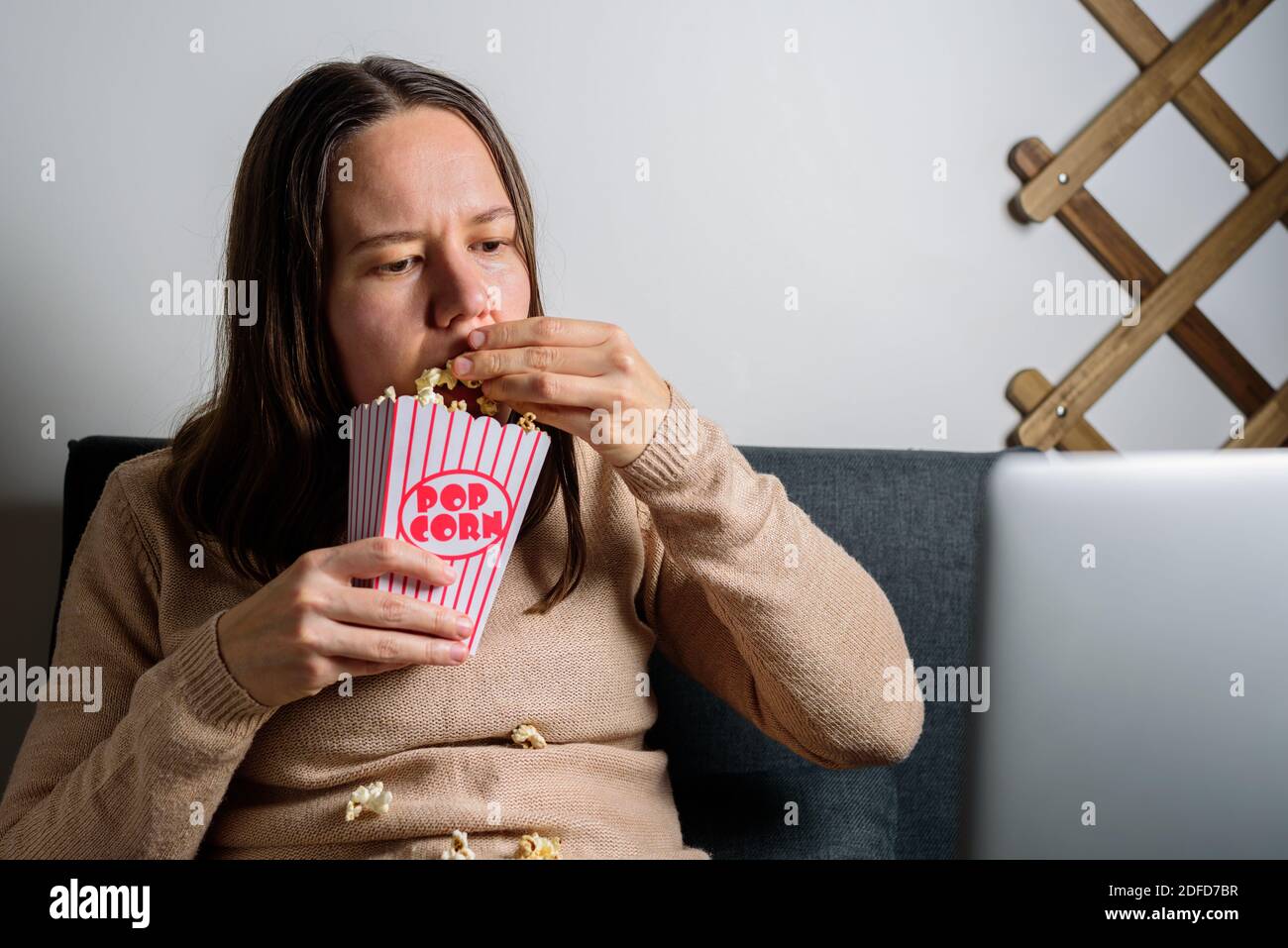 Woman watching movie and eating a lot of popcorn. Overeating Stock ...