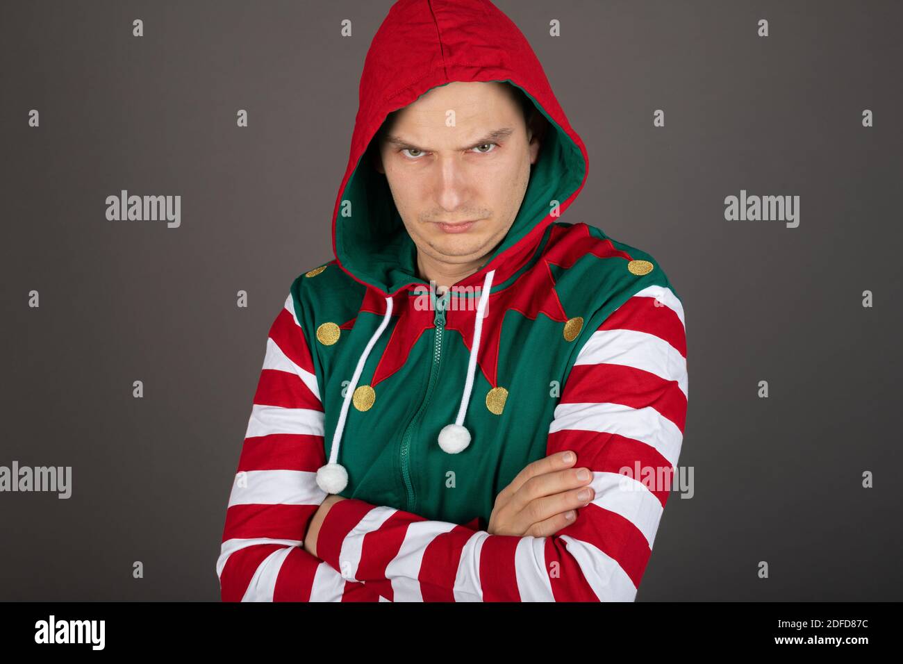 Man wearing Grinch costume making grumpy face on grey background Stock ...