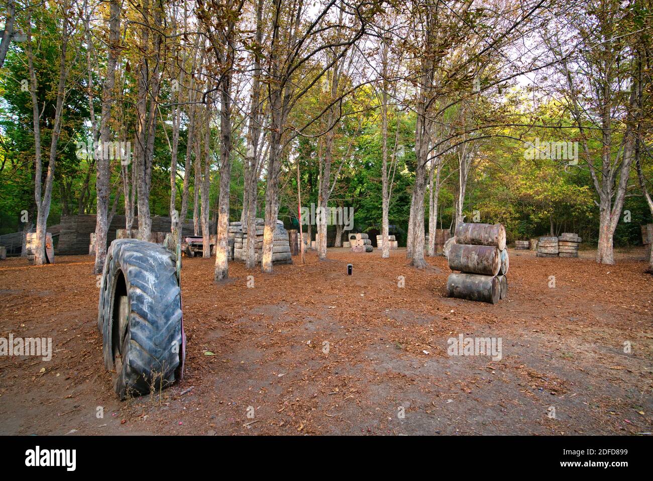 Old rusty barrels and damaged tires at the paintball base where the ...